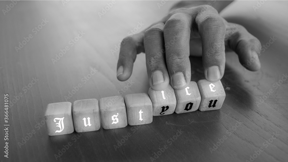 Alphabet in wood Blocks in hands for illustration word of "Justice and ...