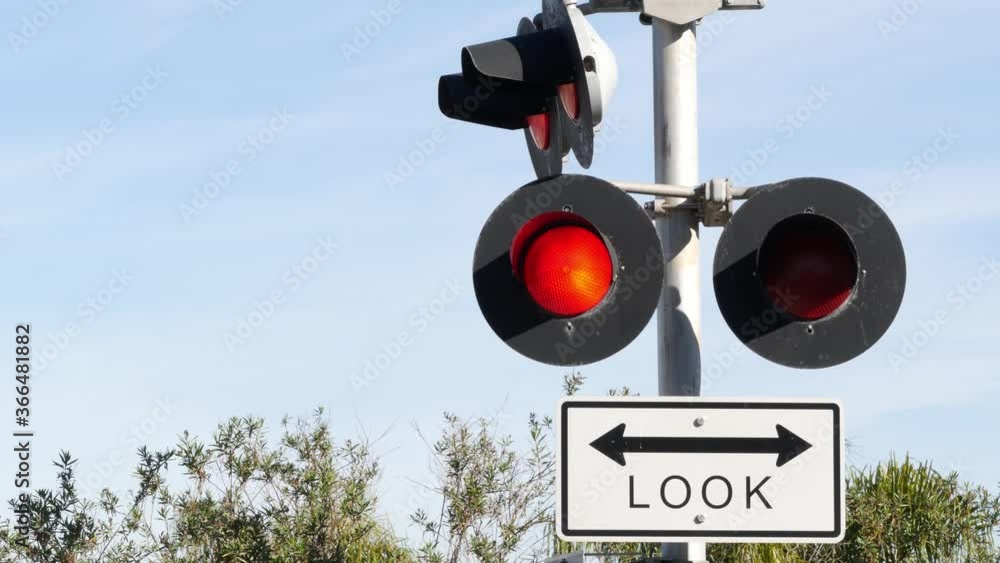 Level crossing warning signal in USA. Crossbuck notice and red traffic ...