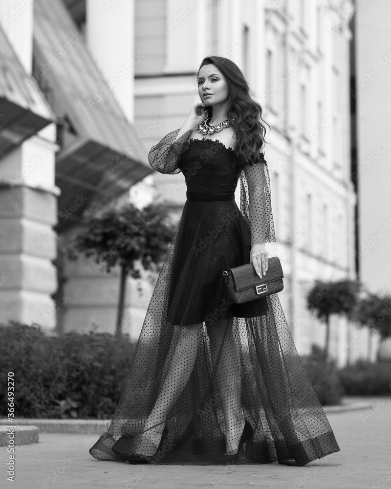 Elegant fashionable female model in red long evening dress with open ...
