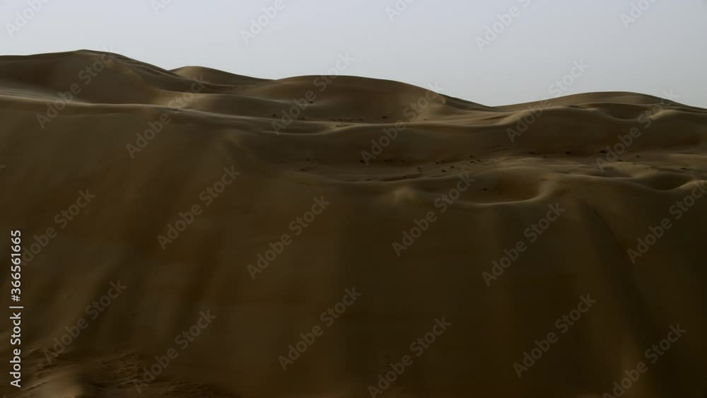 A magnificent solitude shot of the Arabian desert as it zooms out of ...