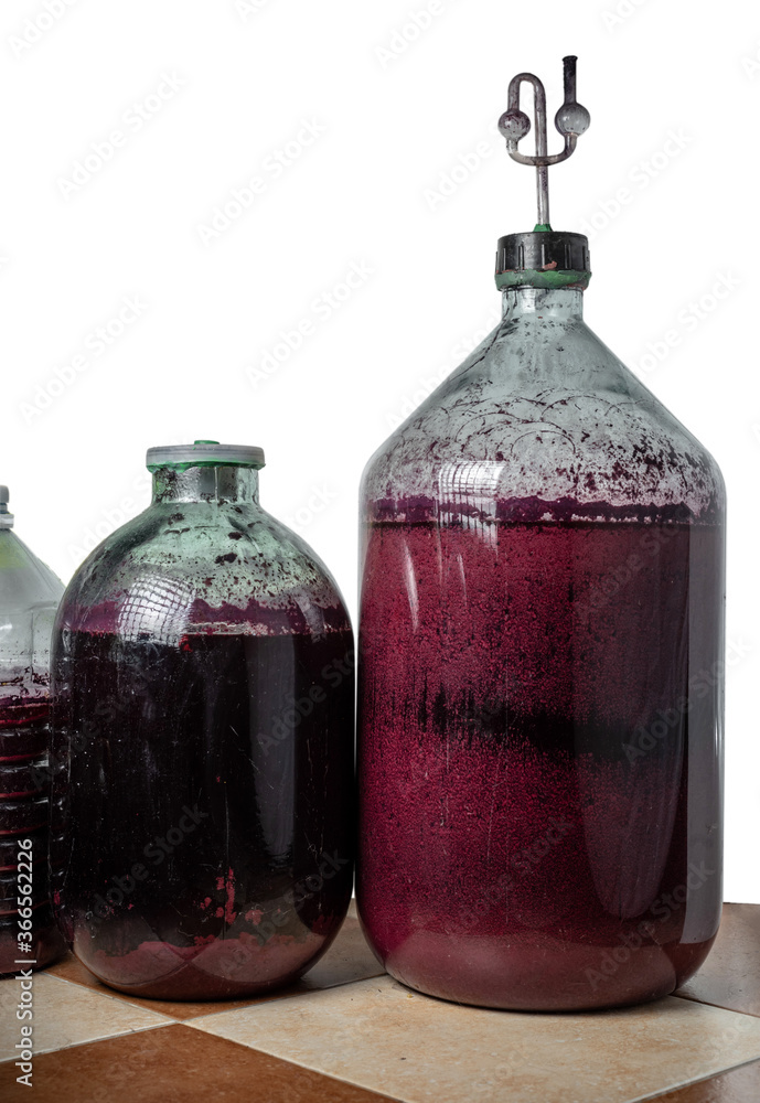 The process of making red homemade wine. Bottles with a must with an ...