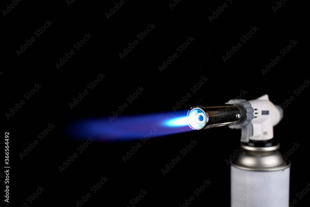 Flamethrower burner gas blow torch Ignition with blue fire flame at ...