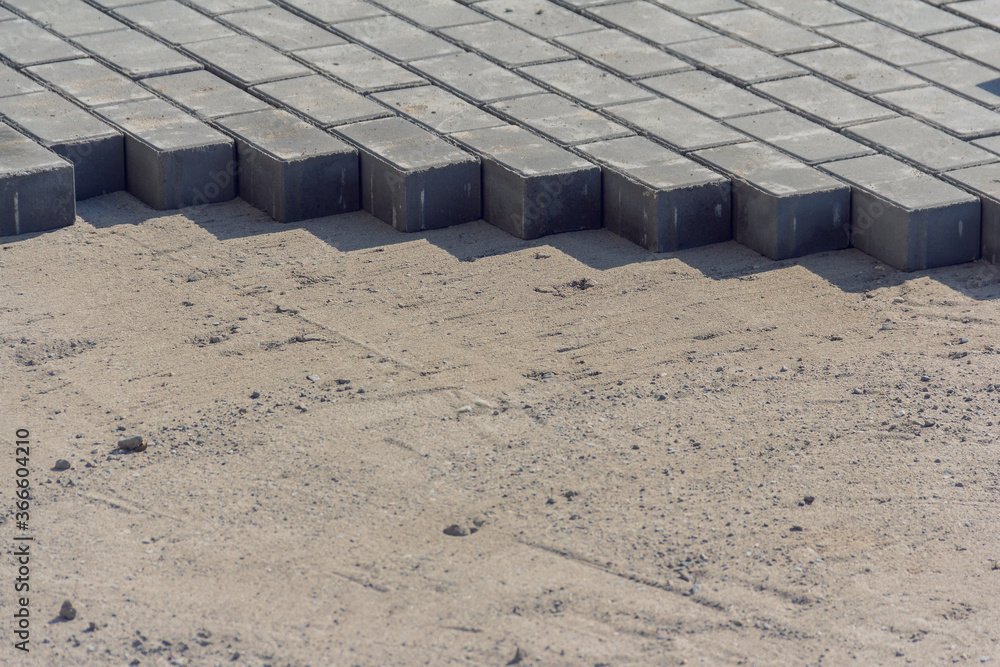 Construction of pavement near the house. Bricklayer places concrete ...