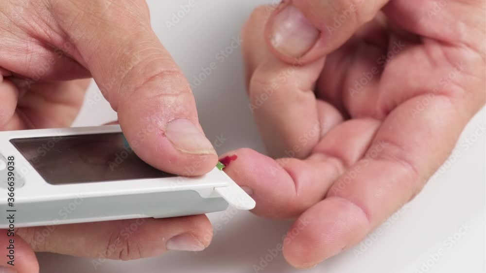 process of taking blood from a finger to a test strip for determining ...