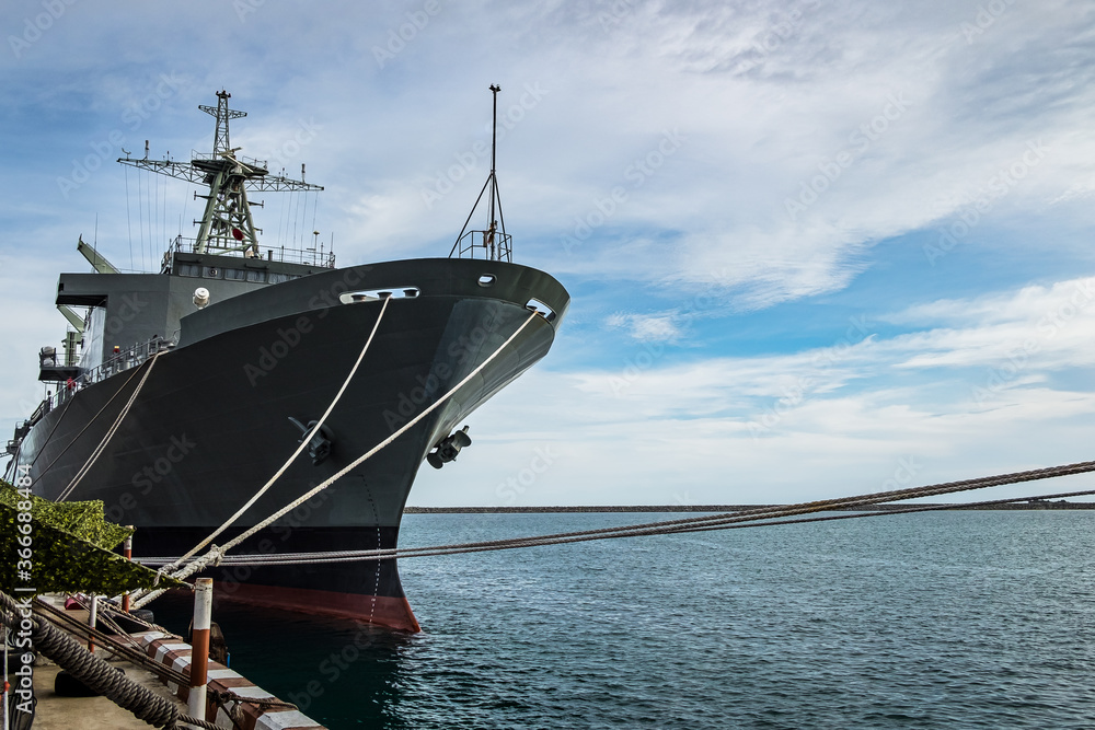 Military navy ship in the port. Gray modern warship with blue sky in ...