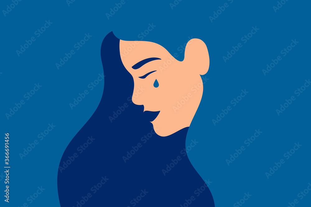 Sad young girl is crying on a blue background. Side view of weeping ...