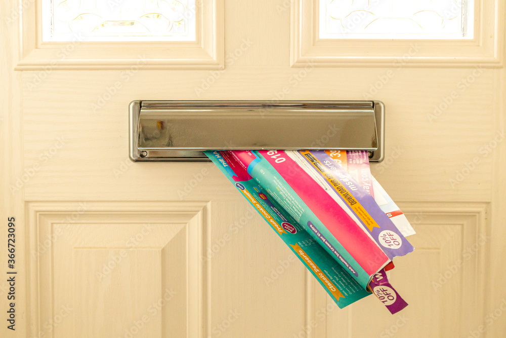 Junk mail stuffed through a letter box (no logos or brands) Stock Photo ...