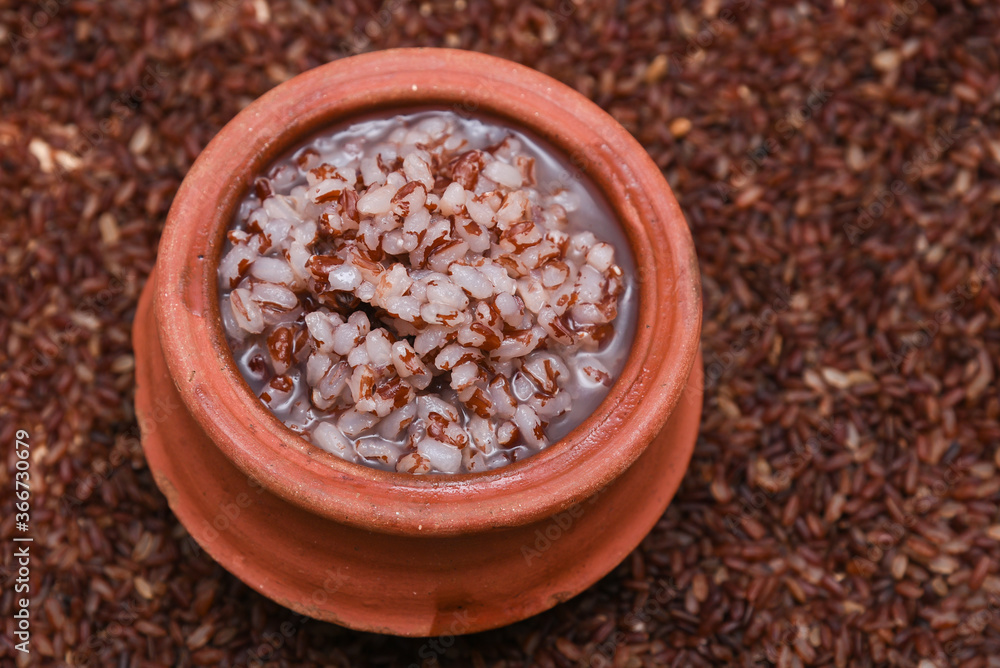 Rice porridge, Kanji, gruel in clay pot palm mat background Kerala ...