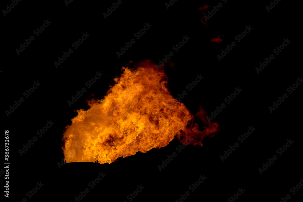 One flame stack at night. This is the flare stack at a refinery. All ...