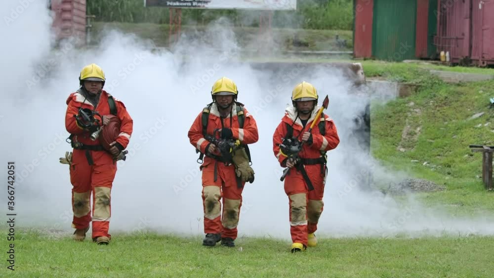 Fireman or firefighter teamwork from fire department wearing fire ...