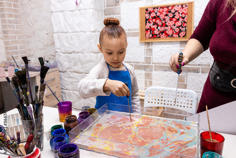 Ebru - Traditional art of origin from Turkey. A woman artist shows a 6 ...