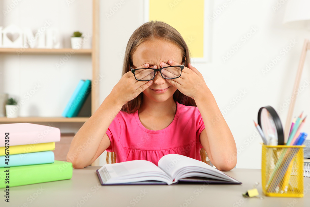 The little girl's eyes hurt from her glasses. Vision problems in ...