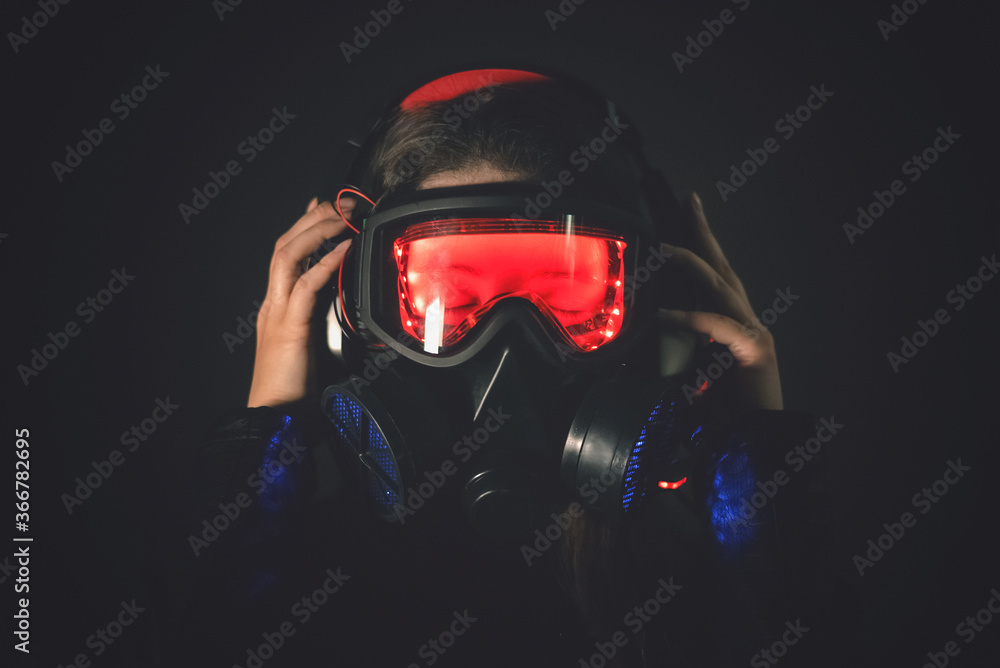 Girl in led face mask is listening a music in the headphones. Stock ...