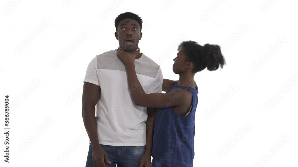 Portrait of young black couple. Lady putting her hands near neck of her ...
