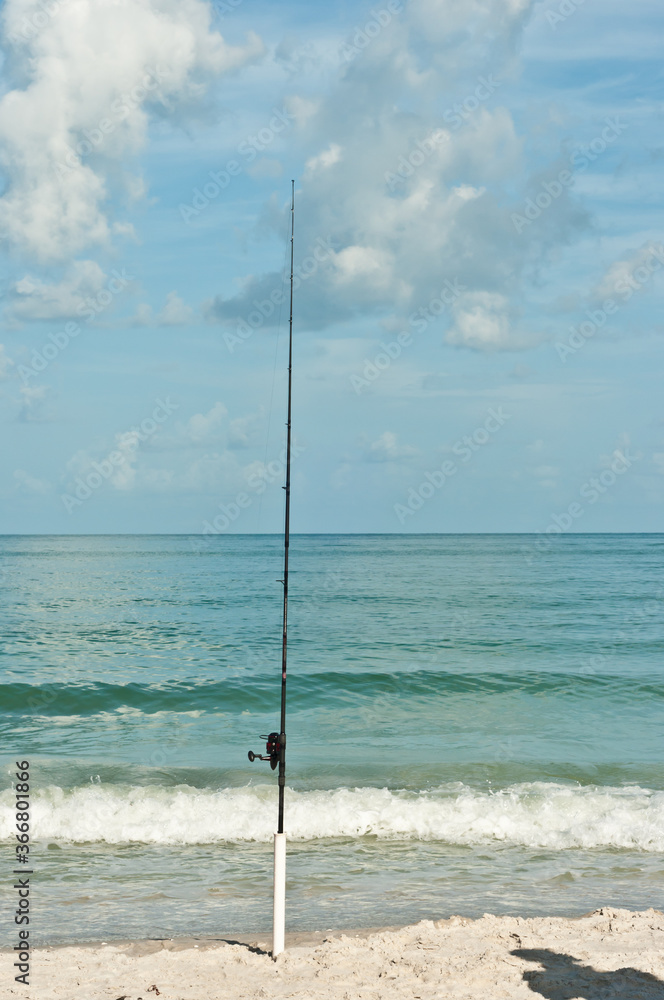 front view, medium distance of a surf fishing rod, in a plastic holder ...