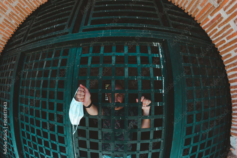 masked man behind the iron gate. The teenager who took off his mask ...