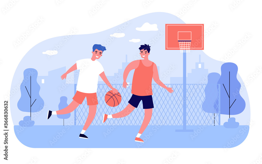 Friends playing basketball on court. Two male players with ball ...