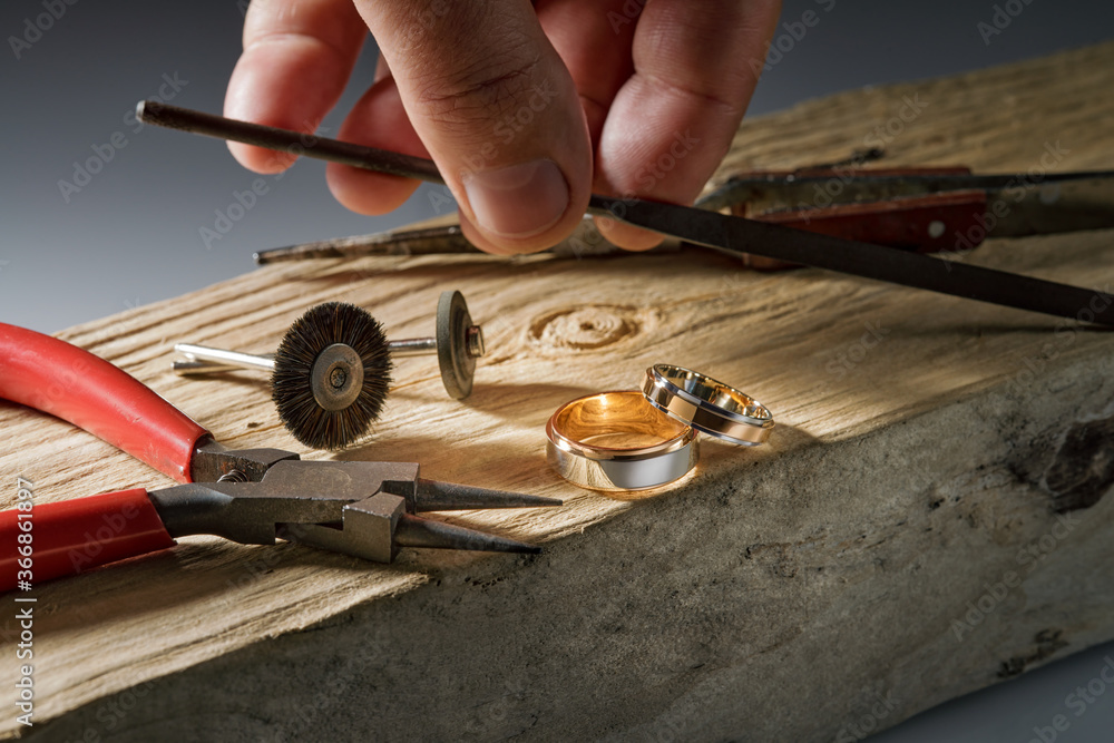 Jewelry craftsmanship desk. Jeweller mans hand close-up. The jeweller ...