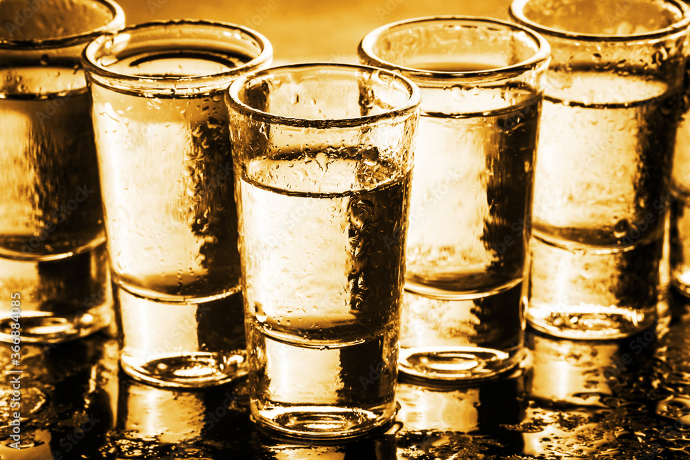 Glass vodka shots. Many alcohol drinks in a row texture. Weekend party ...