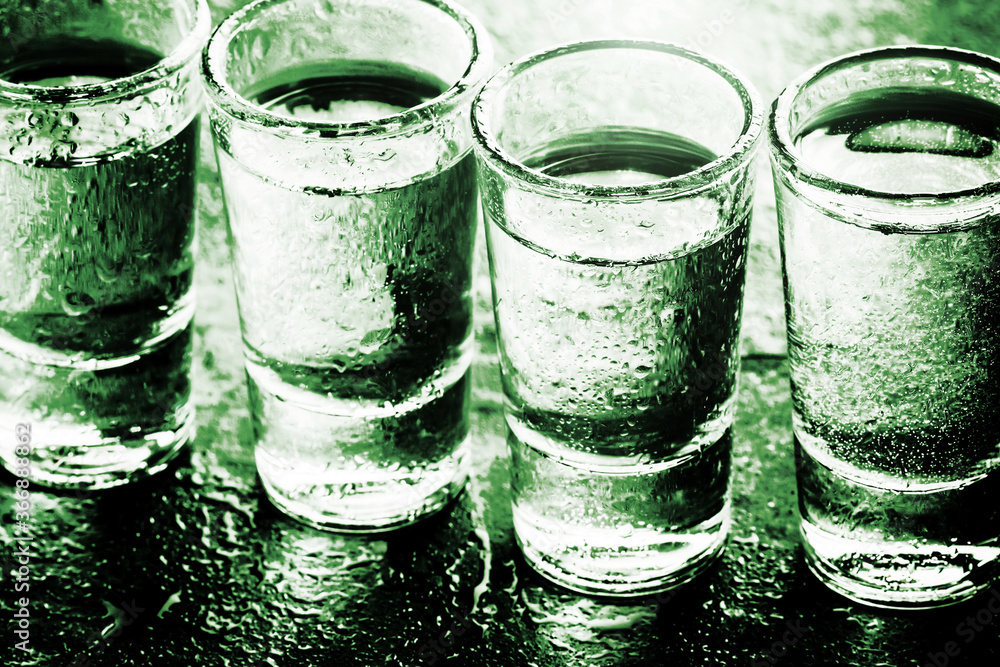 Glass vodka shots. Many alcohol drinks in a row texture. Weekend party ...