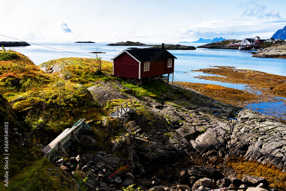 Norwegian coast landscape with a typical red house. Wooden red houses ...