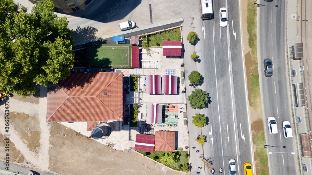aerial view of mosque between the buildings. people are praying in the ...