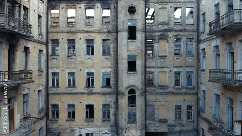 Abandoned ruined 19th century apartment building with a yard-well ...