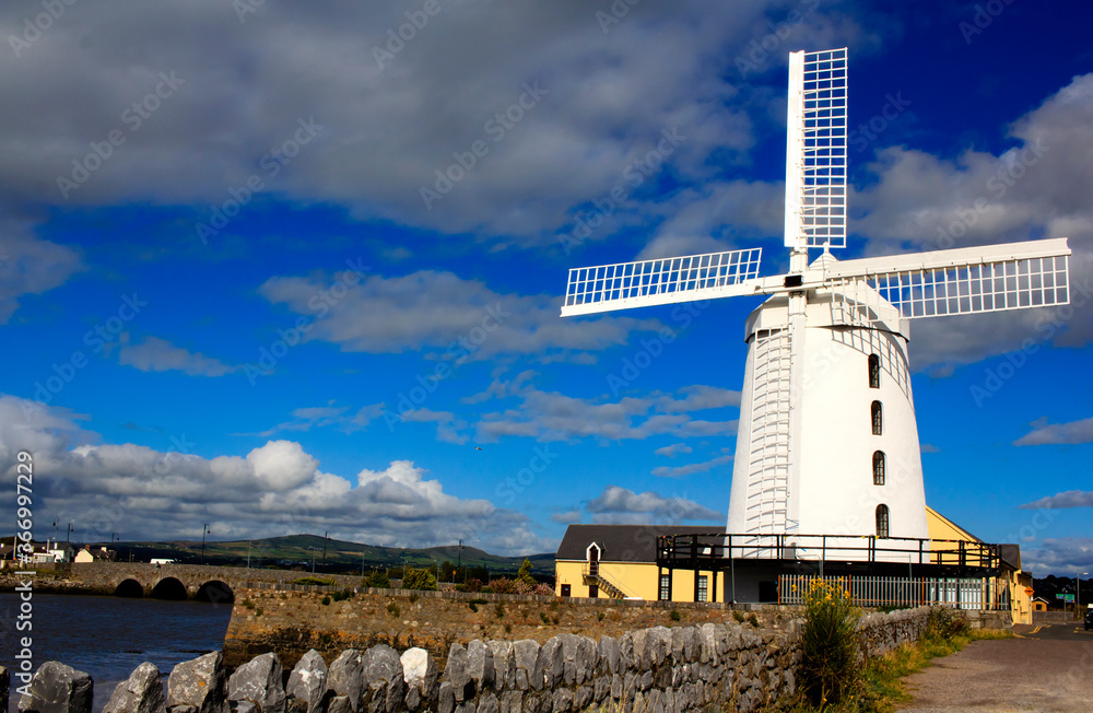 Blennerville Windmill - white windmill with the blue sky with clouds ...