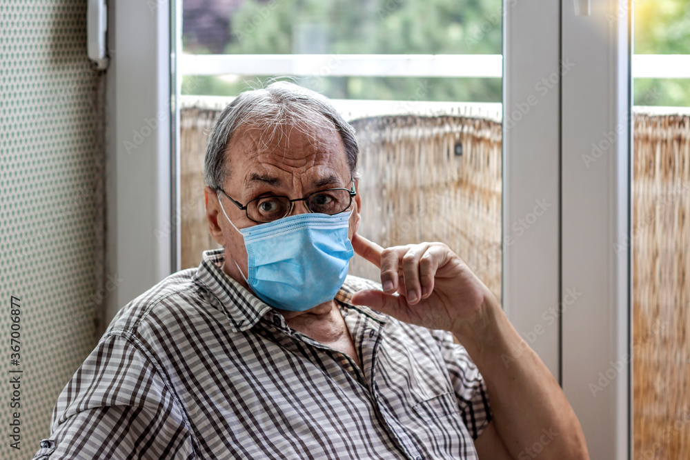 Portrait of a casually dressed youthful senior man at home,wearing an ...