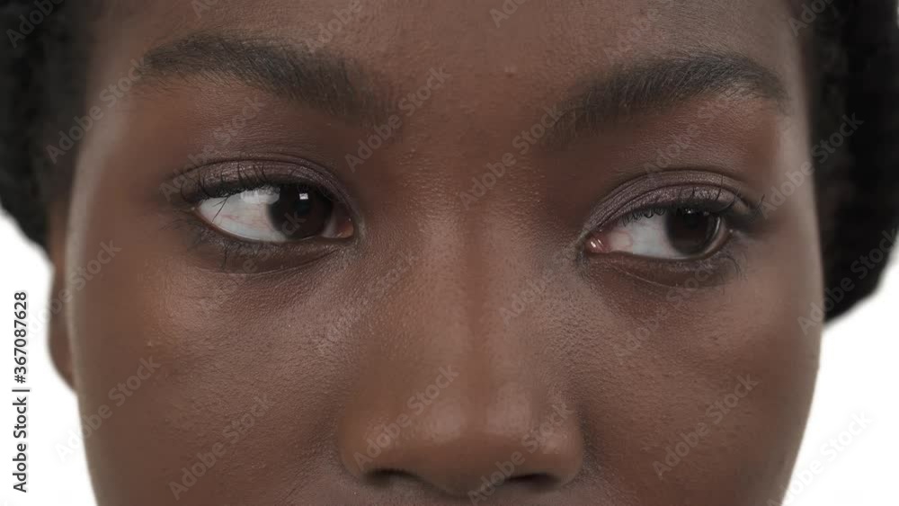 Brown eyes of young black woman opening up and closing. Blinking in ...