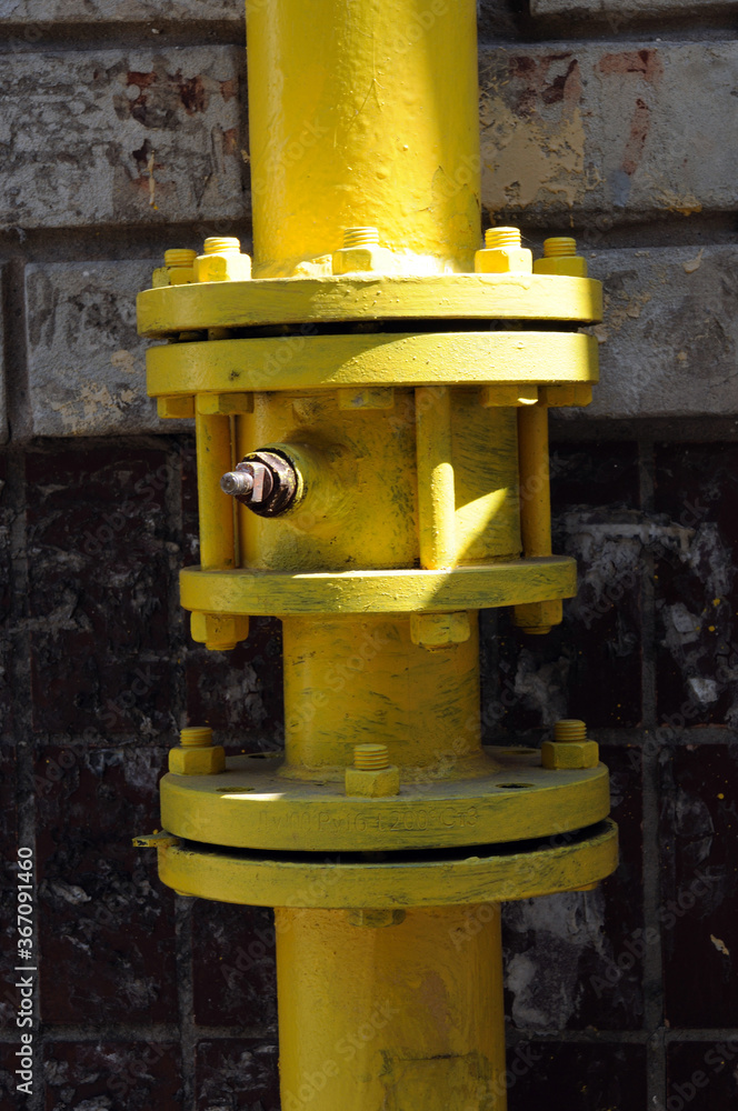 pipe, flanges and valve on a gas pipeline to a residential building ...