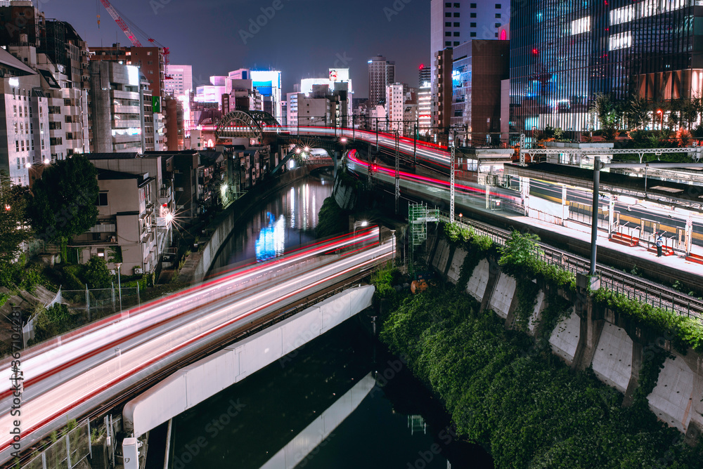 Inner city train lines crossing over river in Tokyo, Japan Stock Photo ...