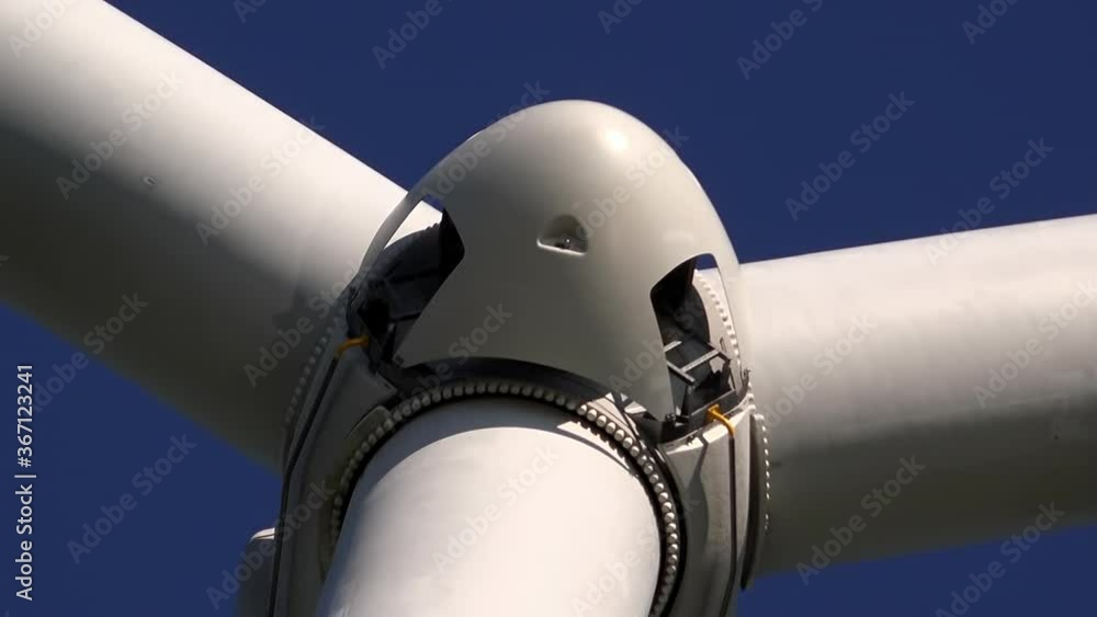 Wind turbine rotor and blades close up, rotating against blue sky Stock ...