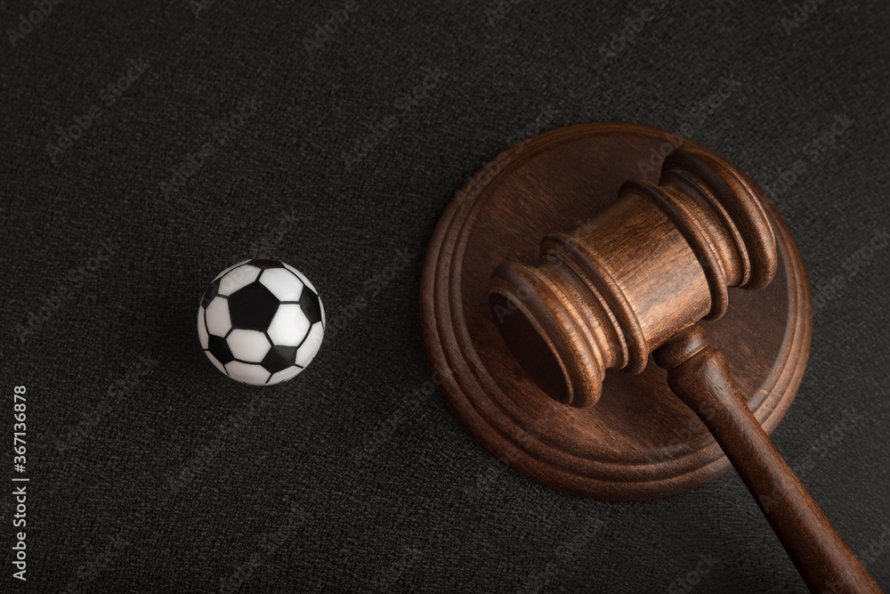 Wooden judge gavel and toy soccer ball. Football coach accused ...