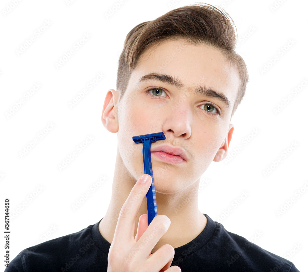 Teenage boy is shaving at first time his mustaches with a razor. Young ...