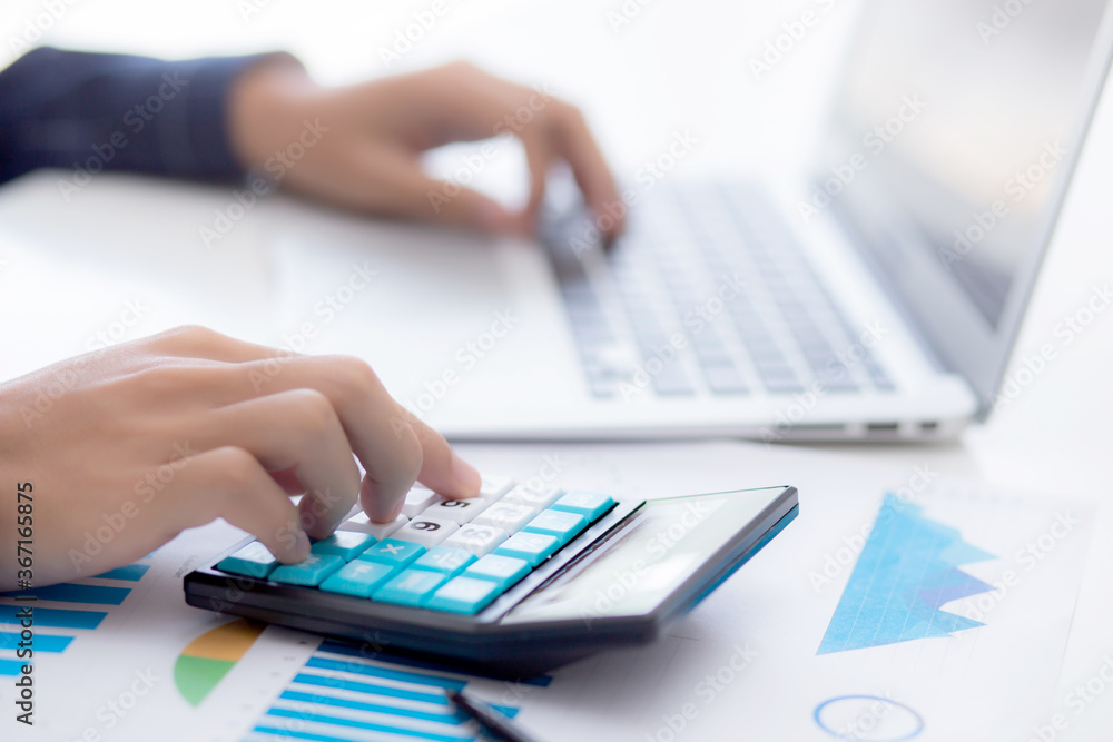 Hand of young asian business man working using calculator for planning ...