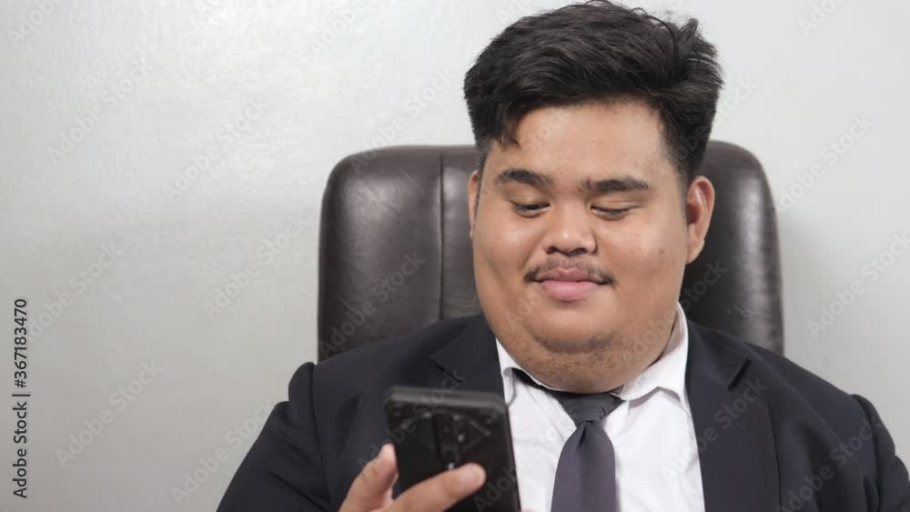 A funny Asian fat businessman wearing a suit look like the head of ...