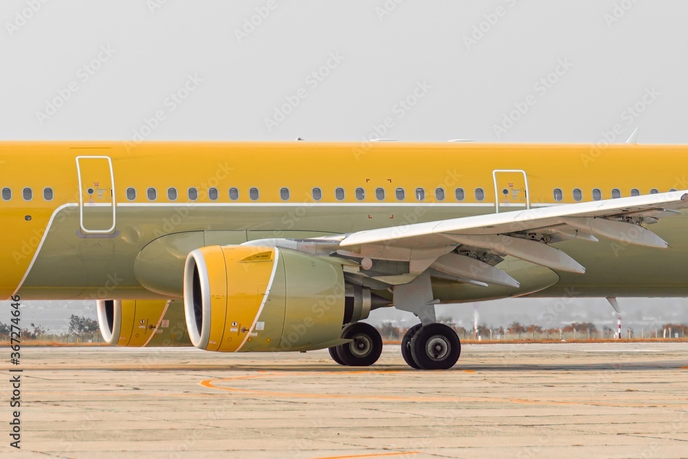 Side view of orange airplane. Wing, engine, windows, landing gear of ...