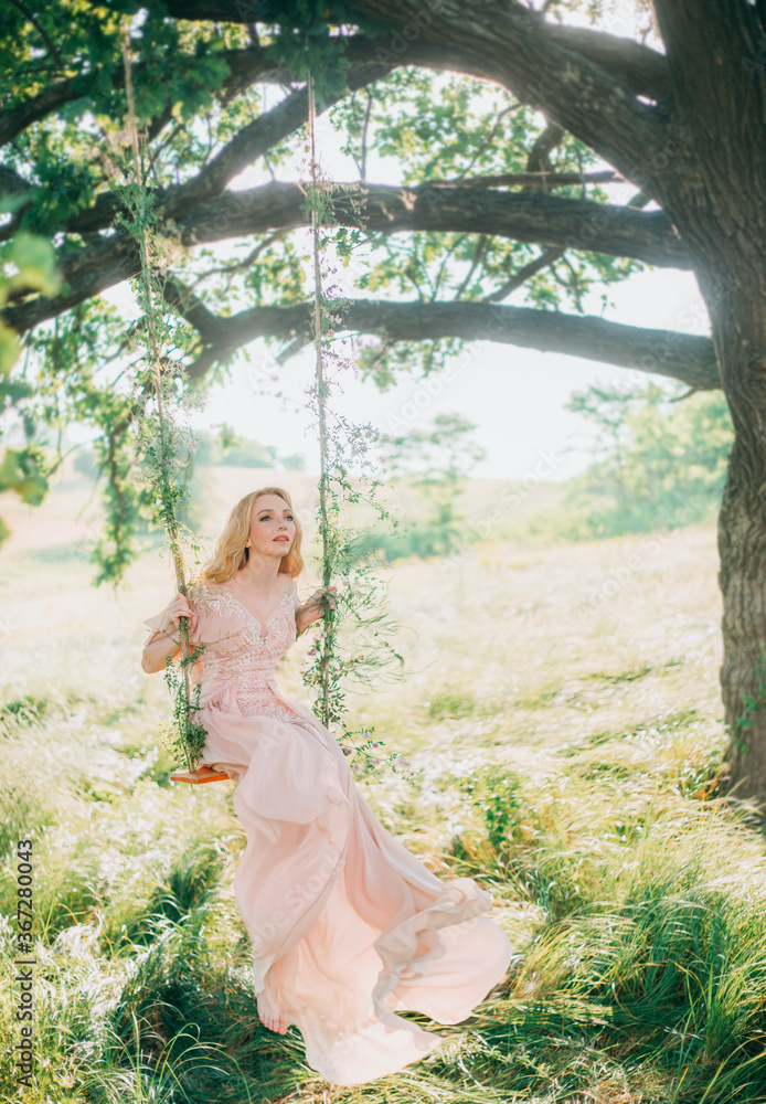 beautiful woman nymph sitting on magic swing. Long beige peach silk ...