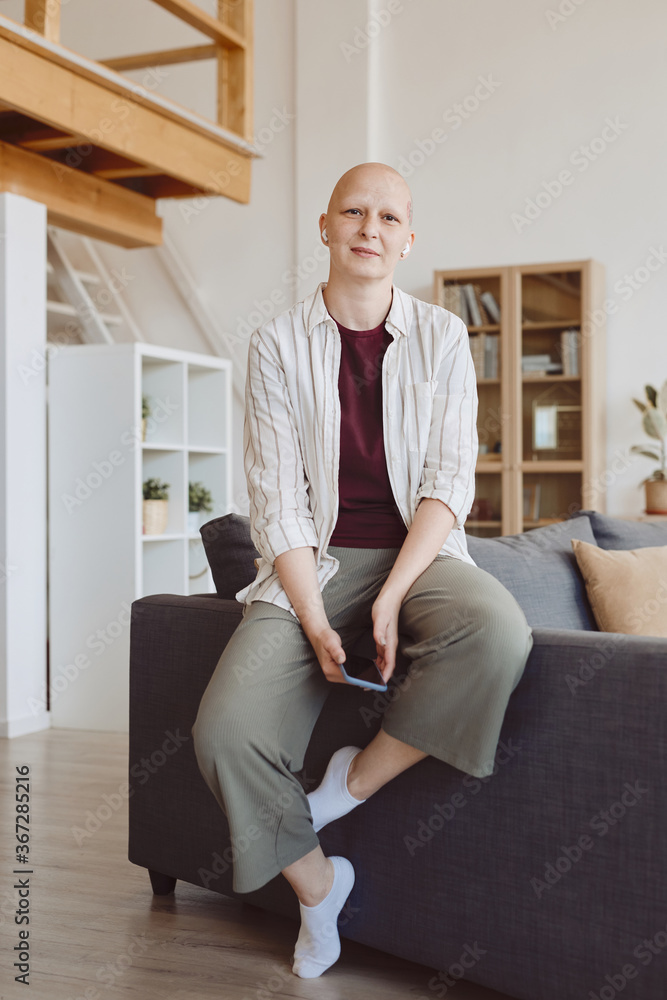 Vertical full length portrait of bald adult woman looking at camera ...