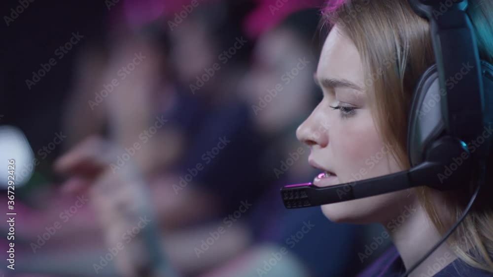 Close-up side view shot footage young woman putting on headset and ...