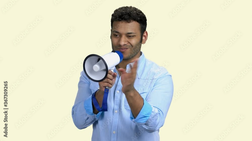 Young man using megaphone on white background. Man leader talking into ...