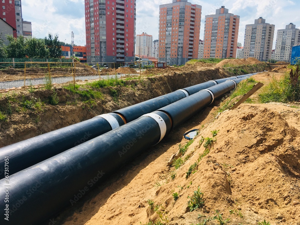 new insulated water pipes in the trench construction site . urban ...