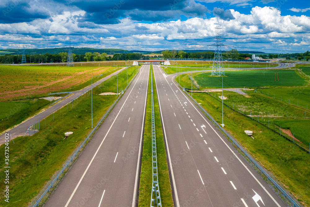 High angle panorama of straight asphalt highway passing through the ...