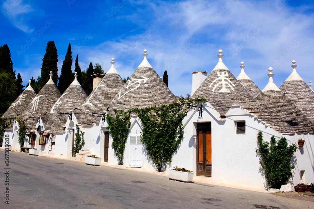 Row of typical trulli houses in Alberobello, Puglia, Italy. Traditional ...