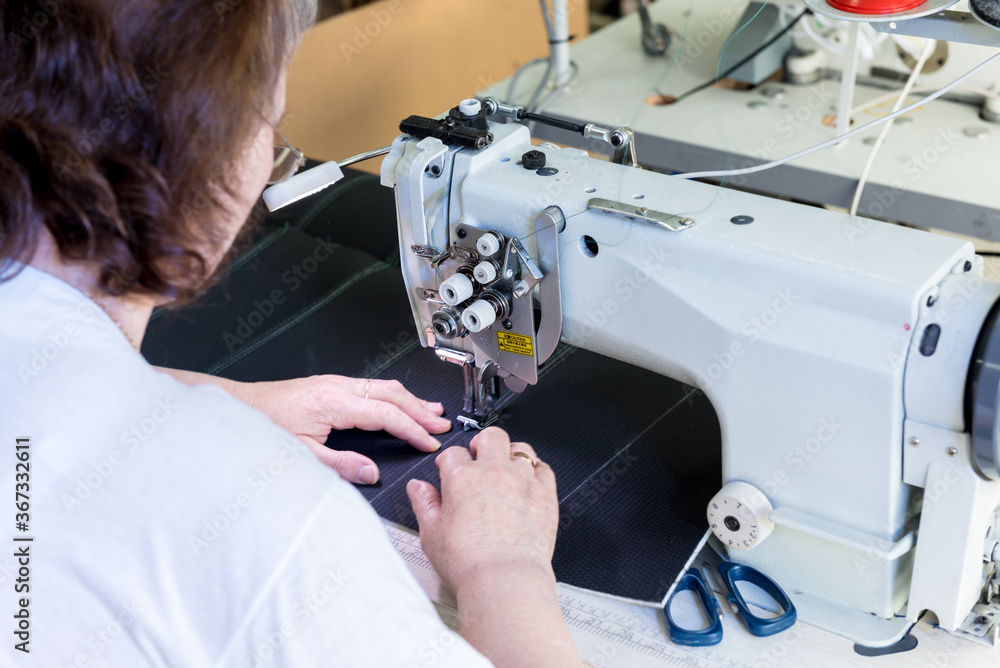 Designer tailor sew the dress. Woman use sewing machine for his work ...