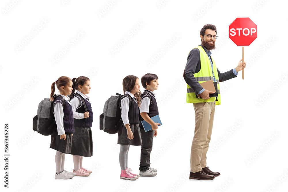 Male teacher with a safety vest and stop sign with a group of ...