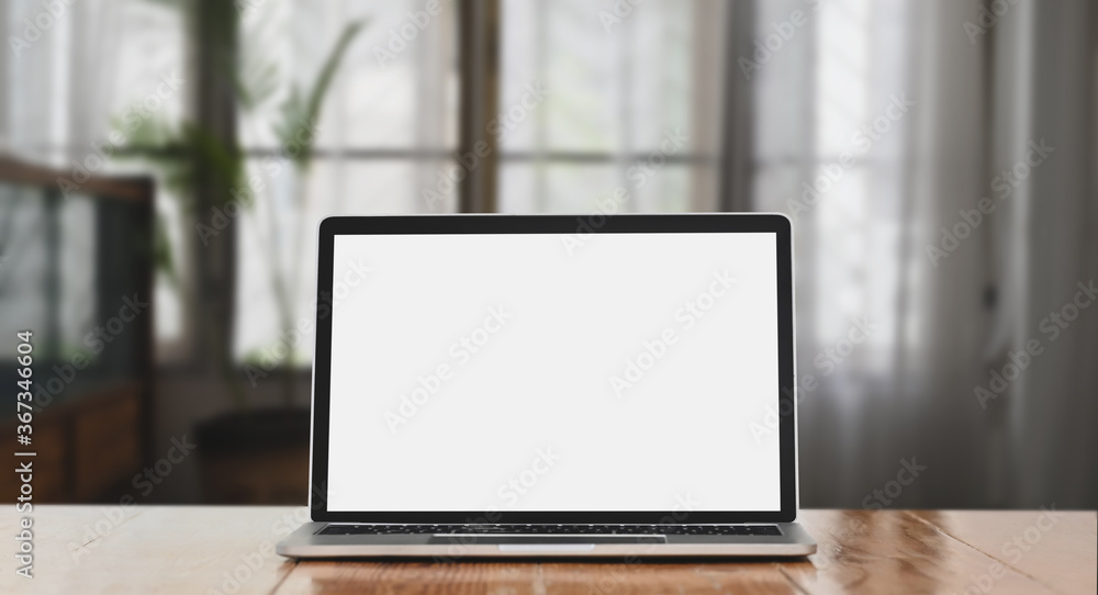 Blank screen computer laptop is putting on a wooden table over the ...