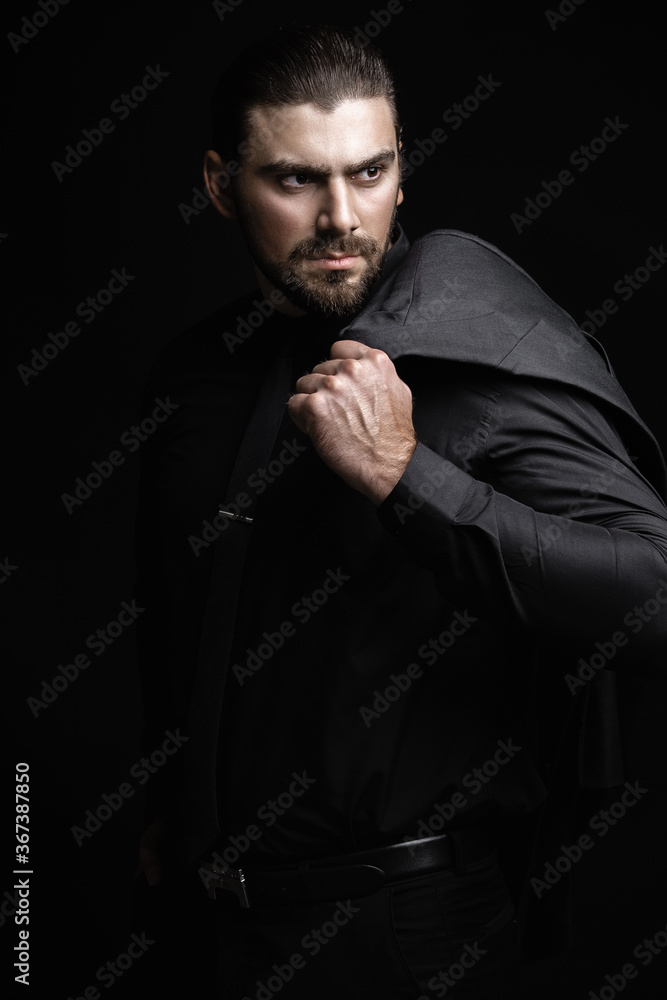 Foto de Strict male portrait. The guy in the classic black suit. Half ...