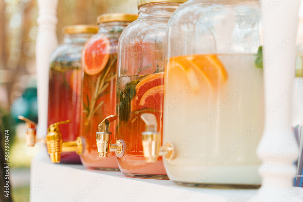 Lemonade dispenser with fruits: grapefruit, orange, lemon. Welcome zone ...